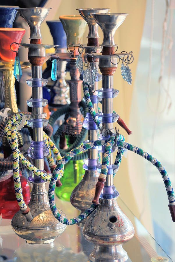 A Row of Colored Hookahs Stand on a Glass Table Display Case Stock ...