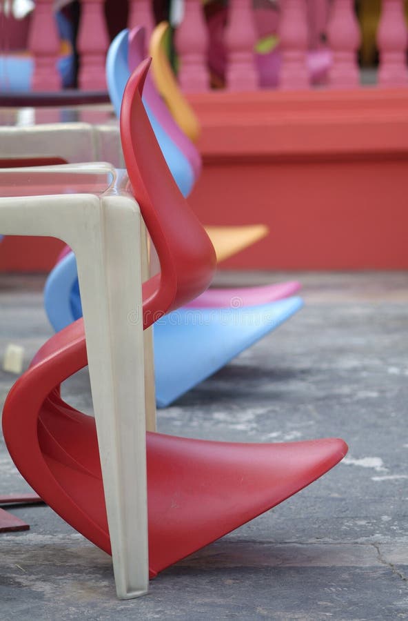 Row of Colourful Plastic Chairs Stock Image - Image of colourful, table ...