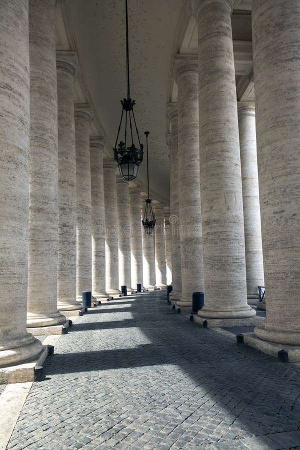 A Row of Columns with a Chandelier Hanging from the Ceiling Stock Image ...