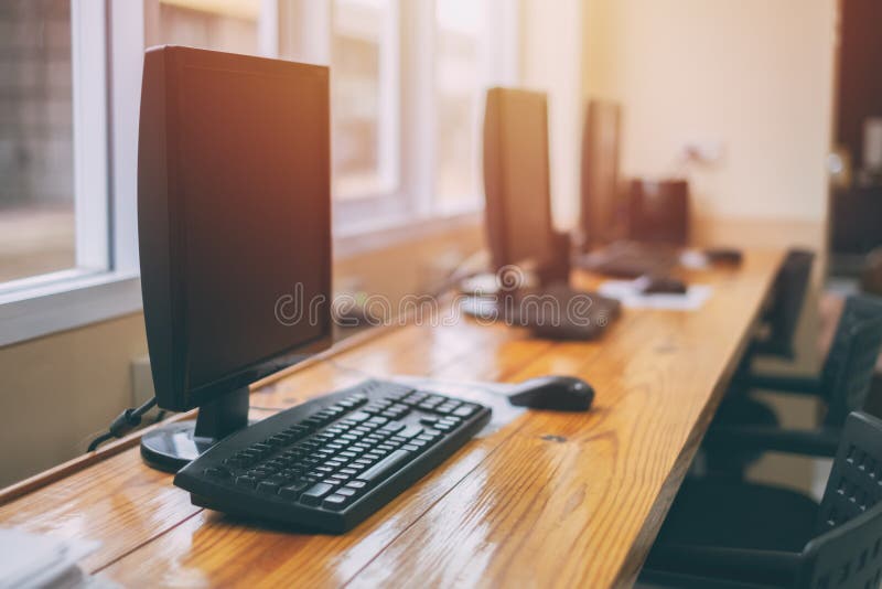 Row of Computer Desktop on Wood Counter Bar for Internet Service in ...
