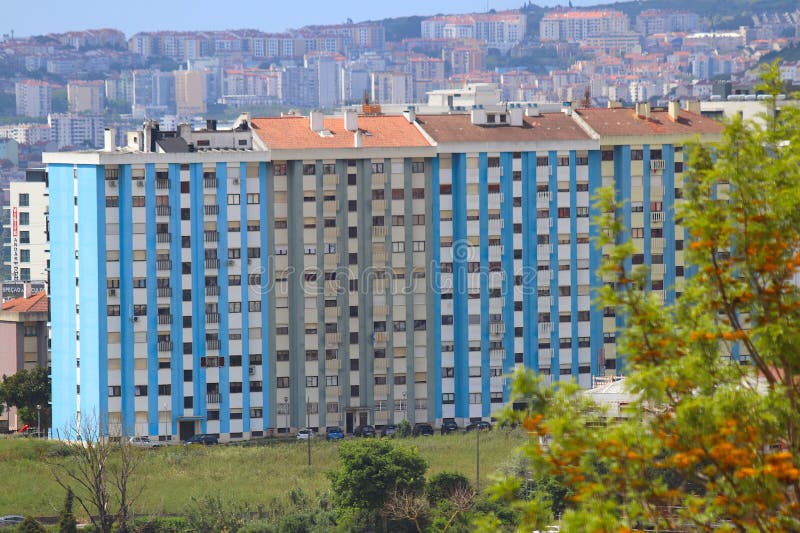 A Row of Contiguous Buildings, with Vegetation in the Foreground and ...