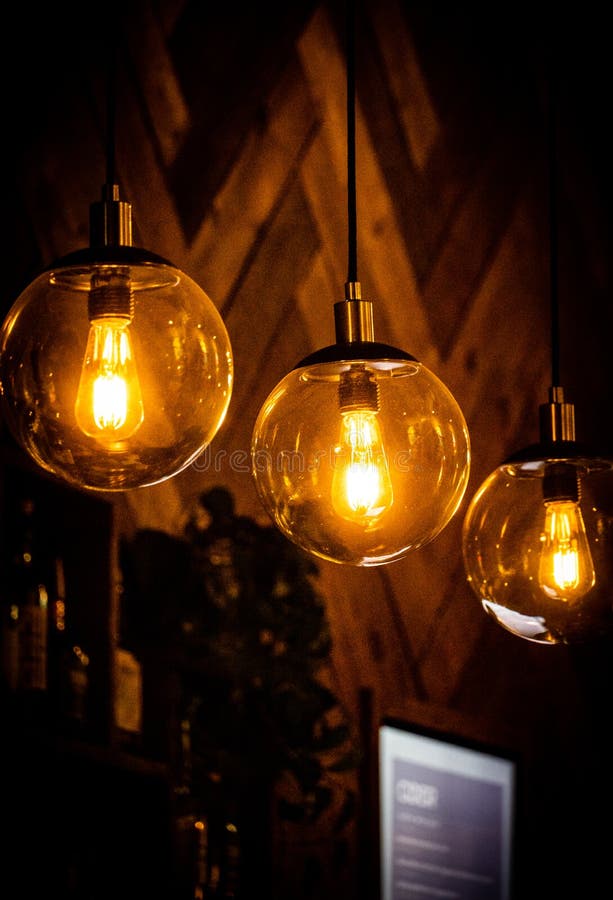 Row of Decorative Light Bulbs Hanging in a Cafe Stock Image - Image of ...