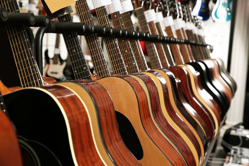 Row of Different Guitars in Music Store Stock Photo - Image of guitars ...