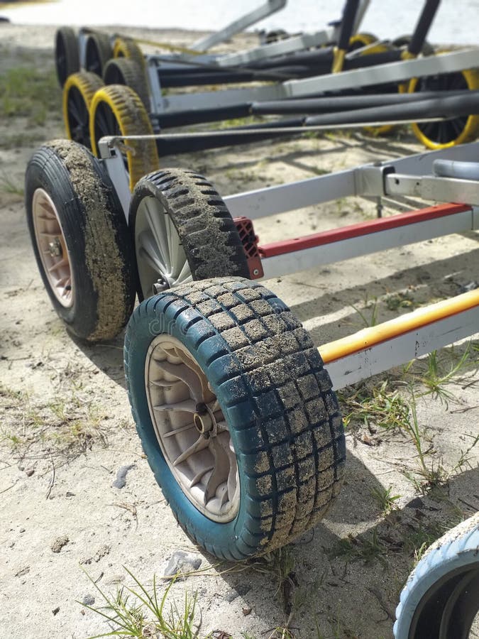 Row of Dinghy Sailing Wagon Wheels on Sand. Boat Trailers. Beach Carts ...