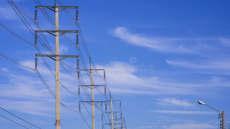 Row of Electric Power Poles with Cable Lines Against White Cloud in ...