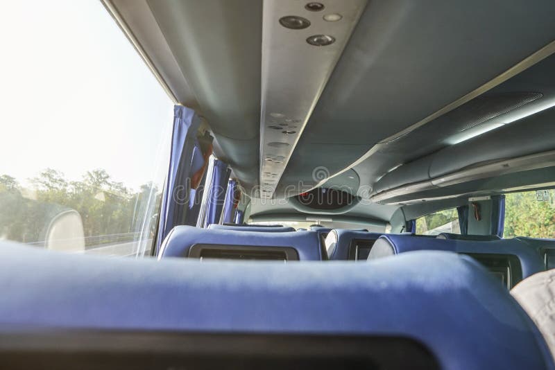 Coach Bus Seats Seen from Back Row, One Passenger Has His Foot in Aisle ...