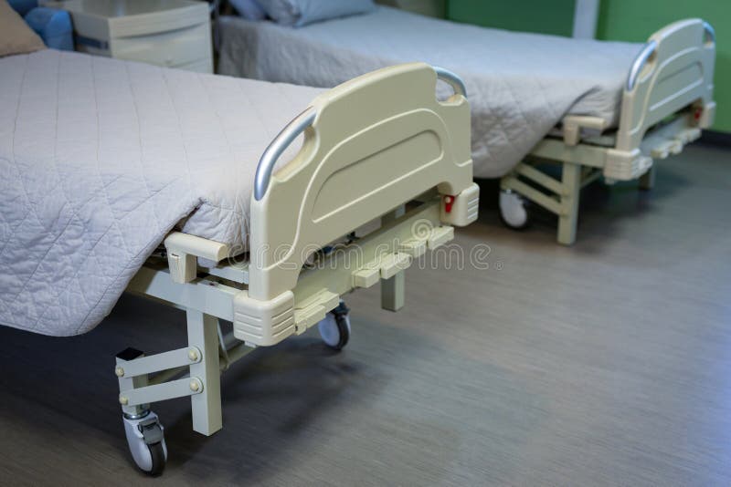 Row of empty hospital beds stock photo. Image of cabinet - 143813538