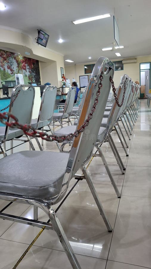 A Row of Empty Metal and Upholstered Chairs, Linked Together with ...
