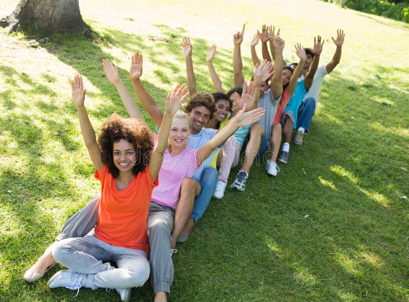 Row of Excited Friends Raising Hands in Park Stock Photo - Image of ...