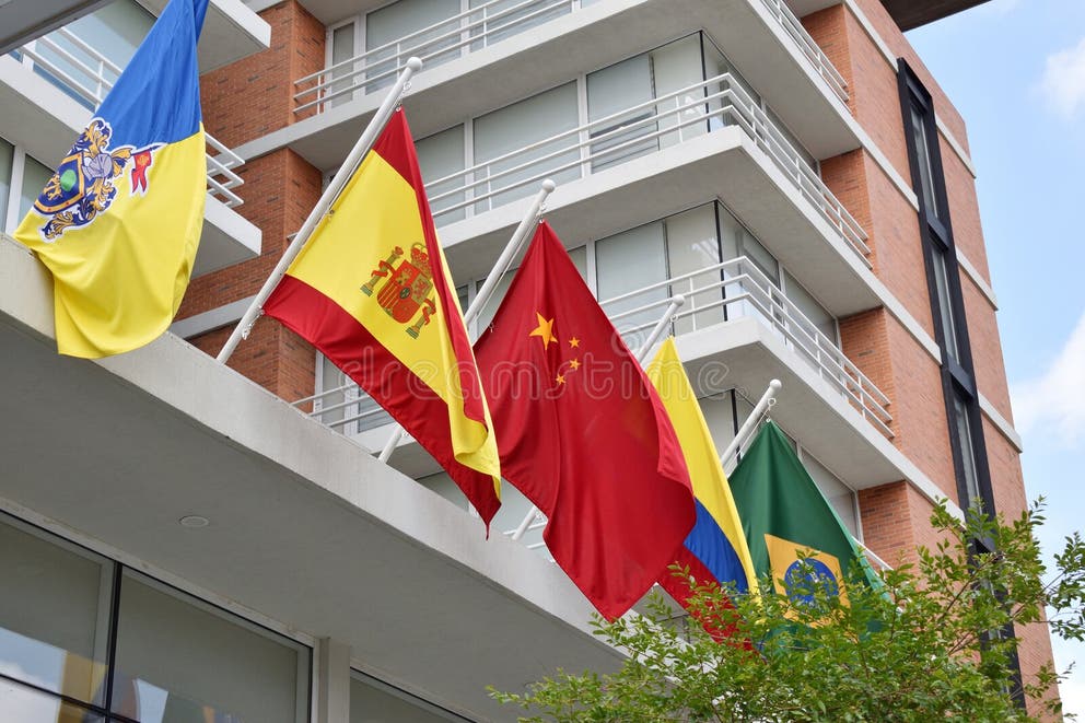 A Row of Flags from Different Countries are Hanging from the Side of a ...