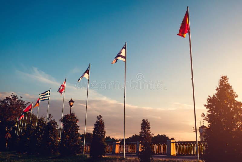 A Row of Flags of Nations on Sunset Sky Background. Flags of Different ...