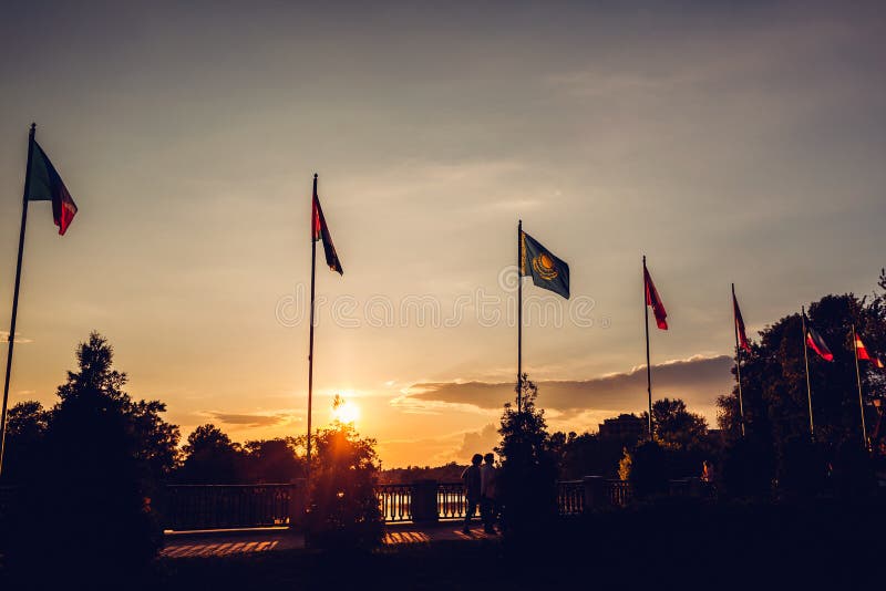 A Row of Flying Flags of Nations on Sunset Sky Background in Park ...
