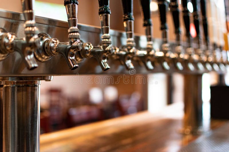 Row of Four Beer Taps Arranged on a Bar Counter Stock Photo - Image of ...