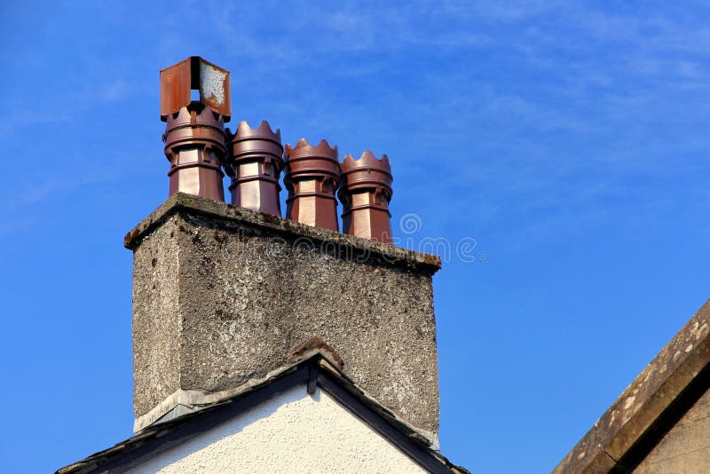 Row of Four Old Ornate Ceramic Chimney Pots on a Rooftop Chimney Stack ...