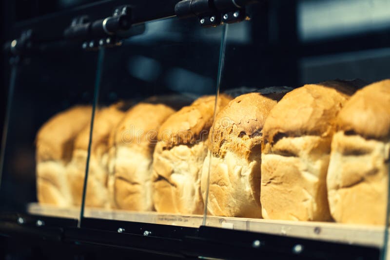 Row of Fresh Bread Loafs Lying on the Shelf in Bakery Stock Image ...