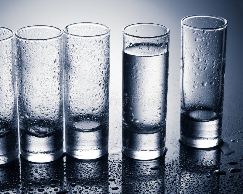 Row of glasses for vodka stock photo. Image of blue - 304724276