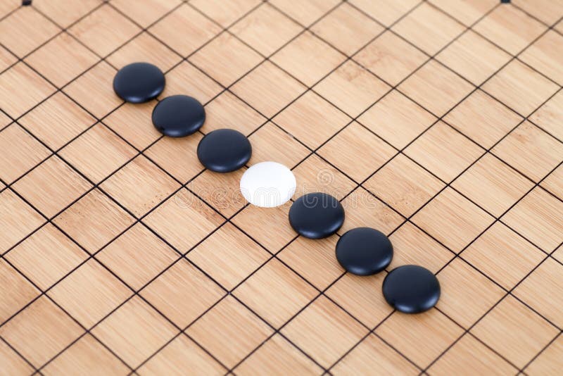 A Row of Go Pieces on a Chessboard Stock Image - Image of white, games ...