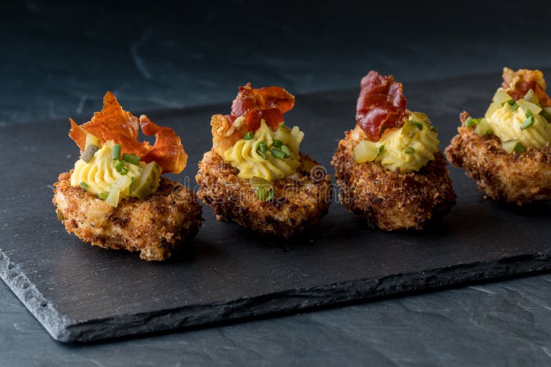 A Row of Gourmet Deep Fried Deviled Eggs Garnished with Chives and ...