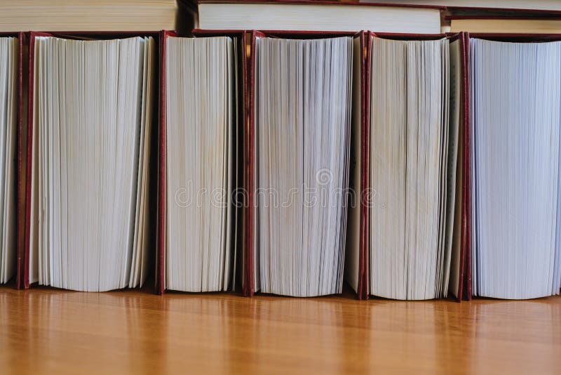 A Row of Half-open Books Lying on the Desk Stock Image - Image of paper ...