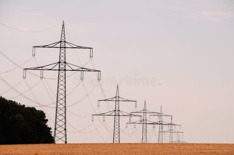 Row of High Voltage Electric Transmission Towers in a Field Stock Photo ... Row of High Voltage Electric Transmission Towers in a Field Stock Photo ...