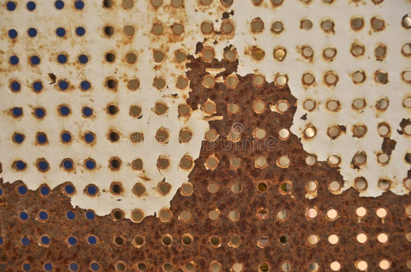 Row of holes in iron board stock image. Image of decoration - 62575213