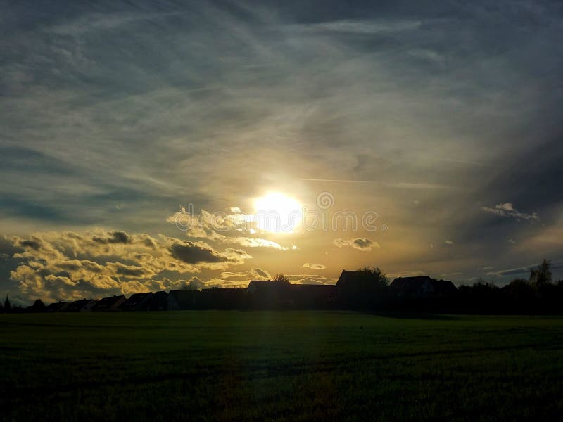 Row of Houses on Field in Backlit Evening Scene Stock Photo - Image of ...