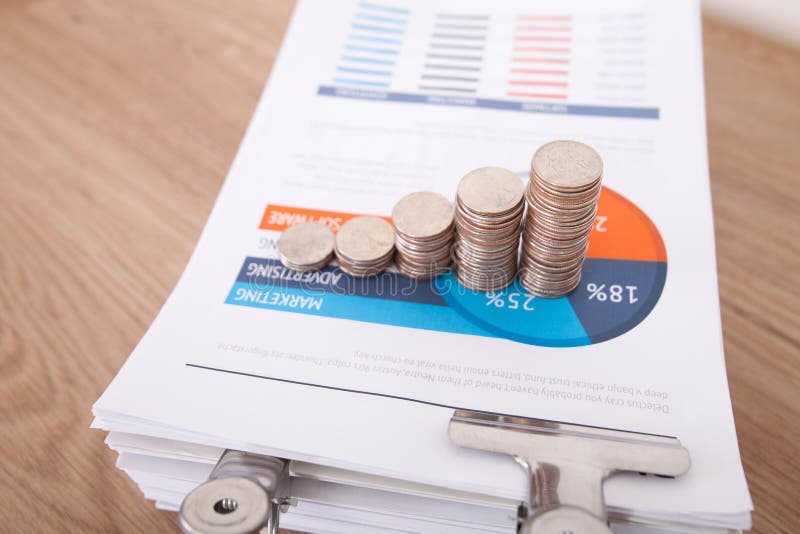 A Row of Increasing Dollar Coins on a Stack of Paper Financial ...