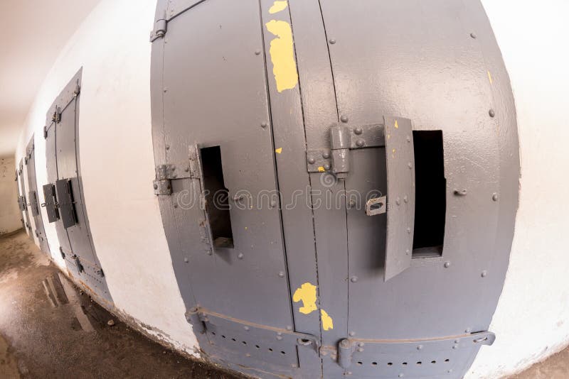 Row of Jail Cell Doors with Feeding Windows Open Stock Image - Image of ...