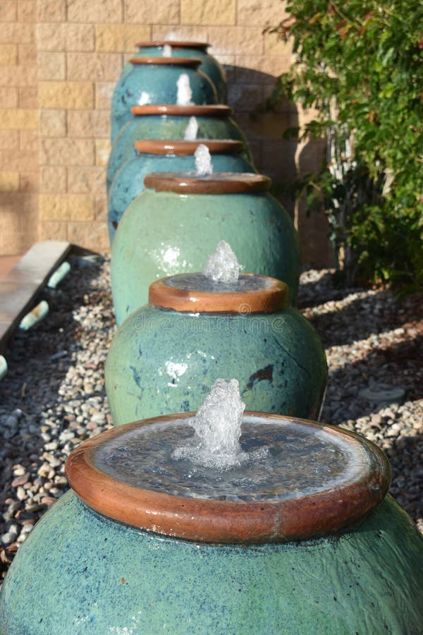 Row of Jug-shaped Fountains in the Garden Stock Image - Image of design ...