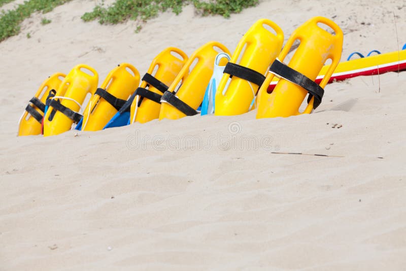 Row of Lifesaving Floation Devices on the Beach Stock Image - Image of ...
