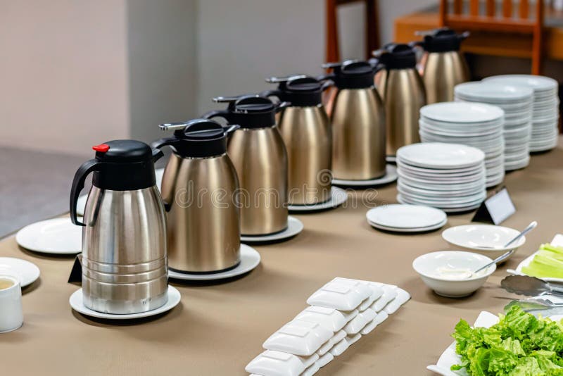 Row of Many Kettles, Milk Bottle and Stack of White Ceramic Dish Ready ...