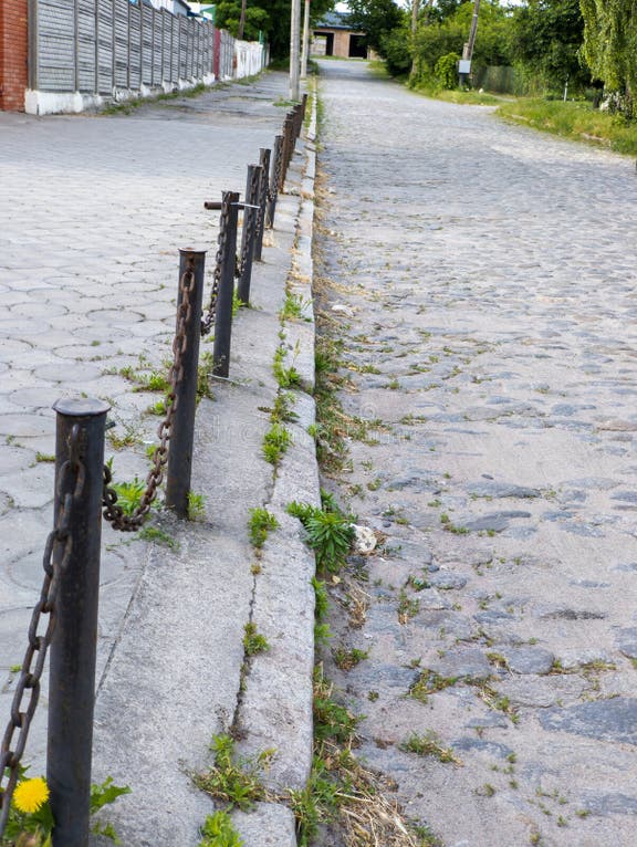 A Row of Metal Poles with Chains on the Side of a Road Stock Photo ...