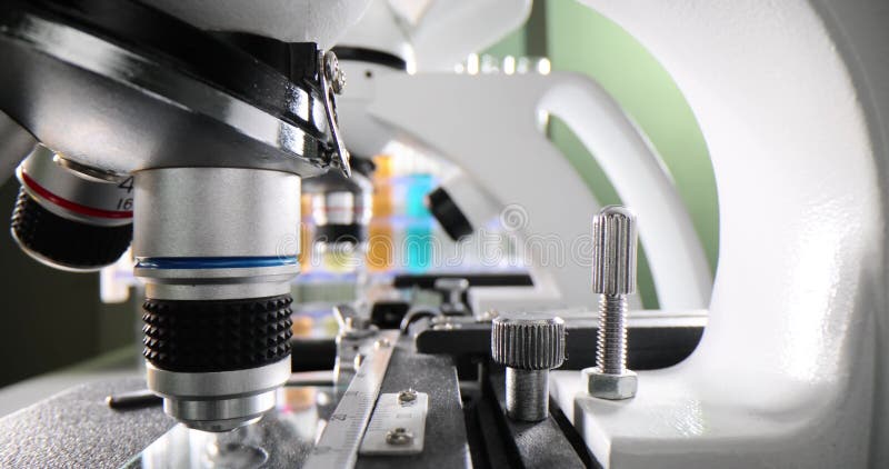 Row of Microscopes and Glassware in a Chemical Laboratory with Liquid ...
