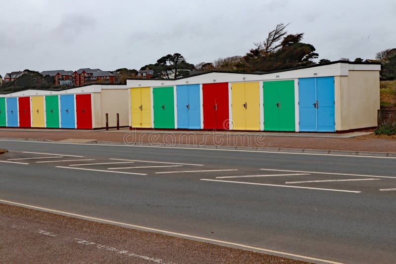 A Row of Multi Coloured Beach Huts Stands Attractively by the Main ...