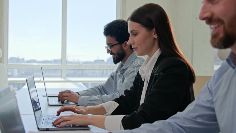 Row of Multiracial Customer Support Agents Provide Service with Laptops ...