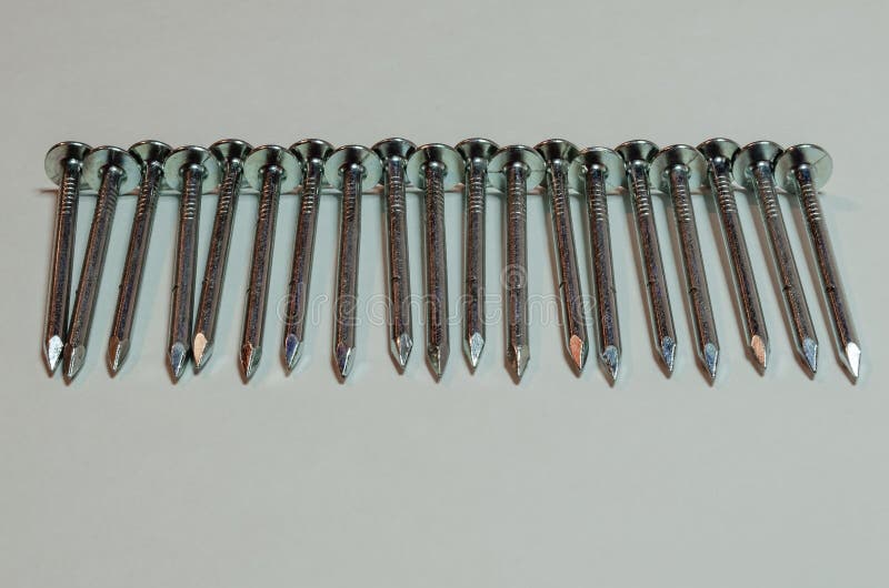 Row of Nails on White Background Stock Photo - Image of pile, laying ...