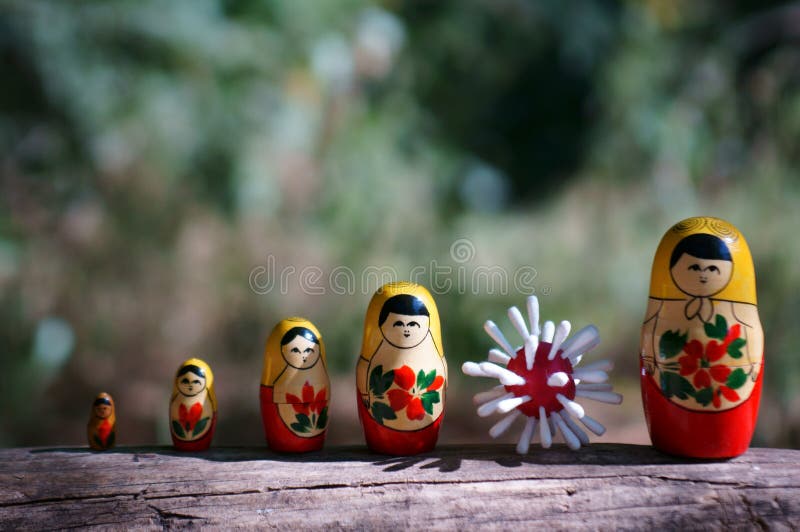A Row of Nesting Dolls on a Colored Background. between Them the Figure ...