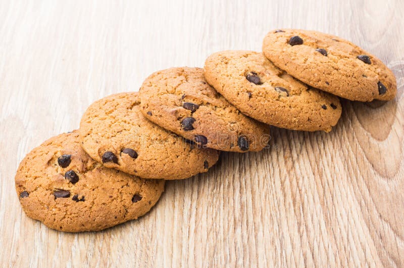 Row of Oatmeal Cookies with Chocolate on Table Stock Photo - Image of ...