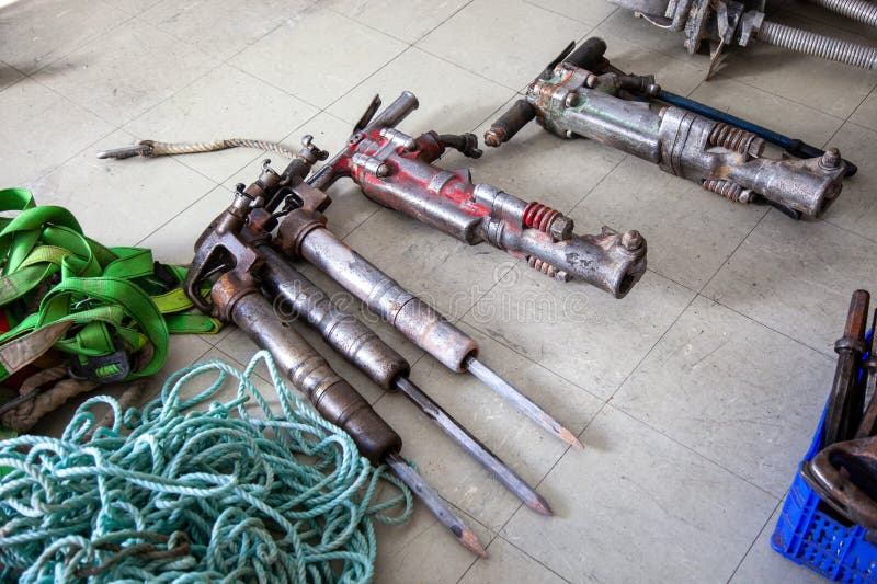 Row of Pneumatic Hammers Neatly Aligned on the Ground, Ready for Use on ...