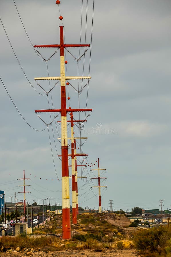 A Row of Power Lines with Red and White Poles Stock Image - Image of ...
