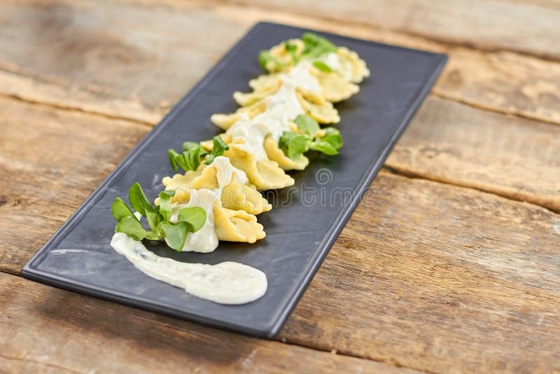 Row of Ravioli on Black Rectangle Plate. Stock Photo - Image of meal ...