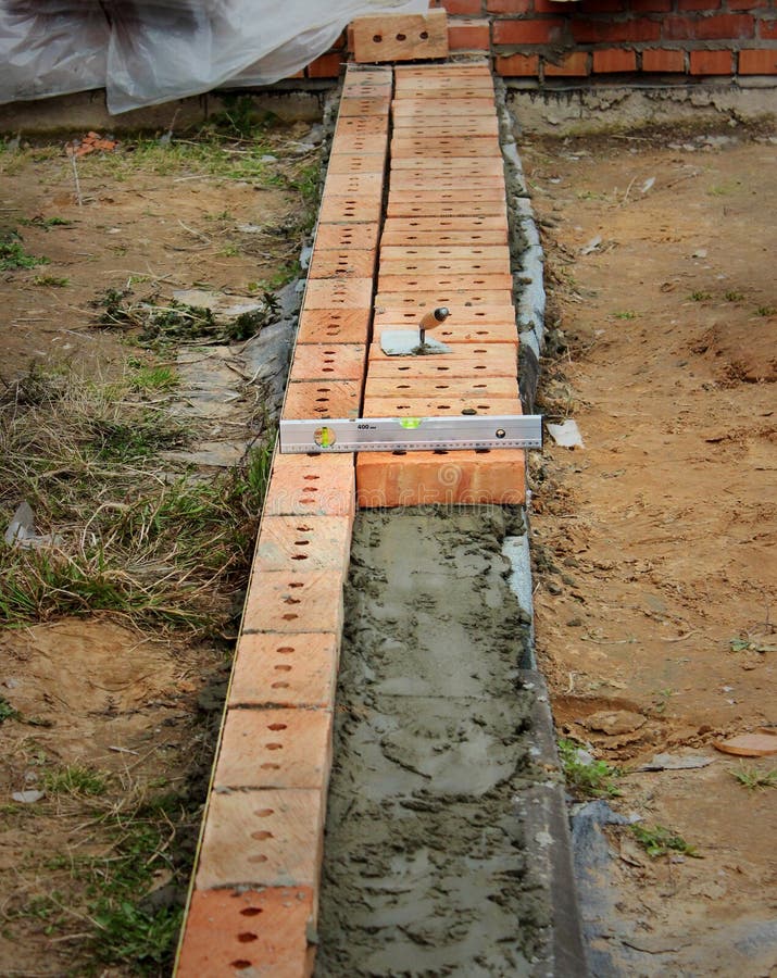 Row of Red Bricks on a Wall. Selective Focus. Red Bricks on Top of a ...