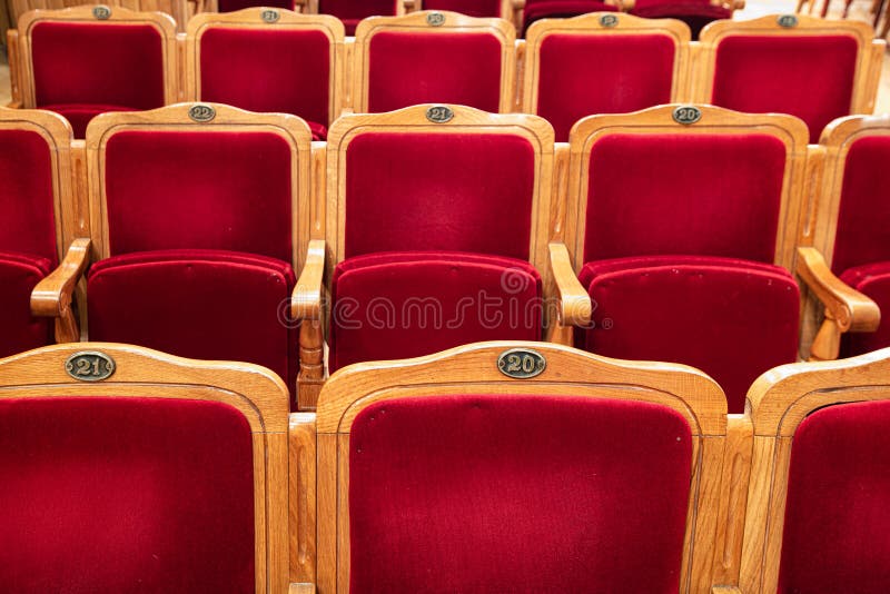 Row of red seats theatre stock image. Image of color - 208503073