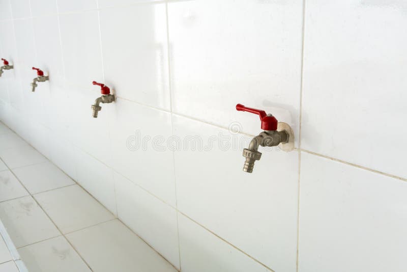 Row of Red Water Taps Against White Wall Stock Photo - Image of long ...