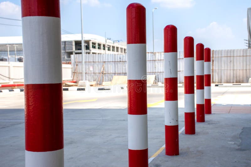 Row of Red and White Traffic Barrier Pole on Car Parking Lot Stock ...
