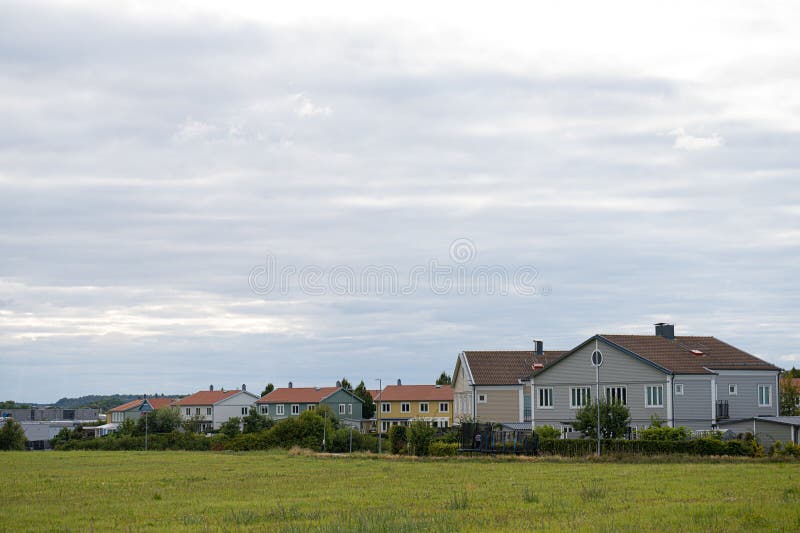 Row of Residential Houses by a Green Field.. Stock Photo - Image of ...