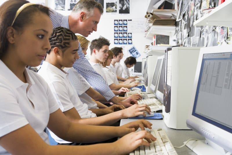 Schoolchildren and Teacher Studying Stock Photo - Image of smiling ...