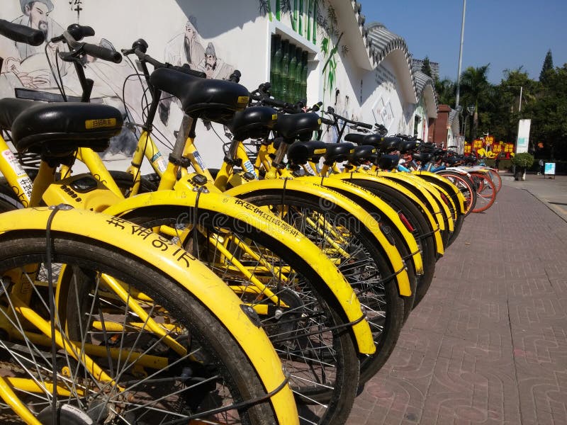 Shenzhen, China: a Row of Shared Bicycles Parked on the Sidewalk ... Shenzhen, China: a Row of Shared Bicycles Parked on the Sidewalk ...