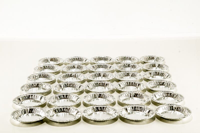 A Row of Silver Plates are Lined Up on a White Table Stock Photo ...