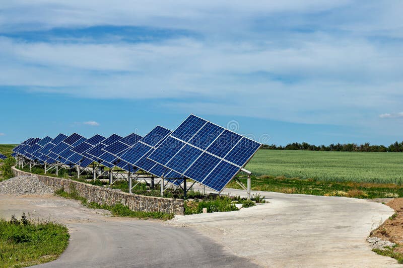 A Row of Solar Panels on the Side of a Dirt Road Stock Photo - Image of ...